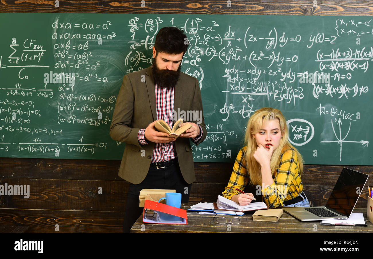 High school or college students studying and reading together in ...