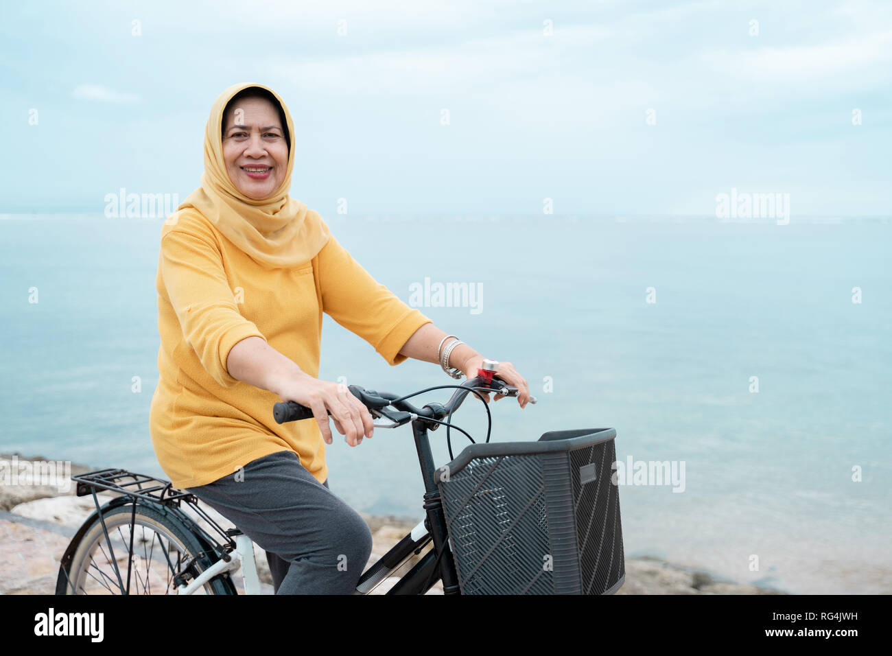 muslim woman with scarf riding a bike Stock Photo - Alamy