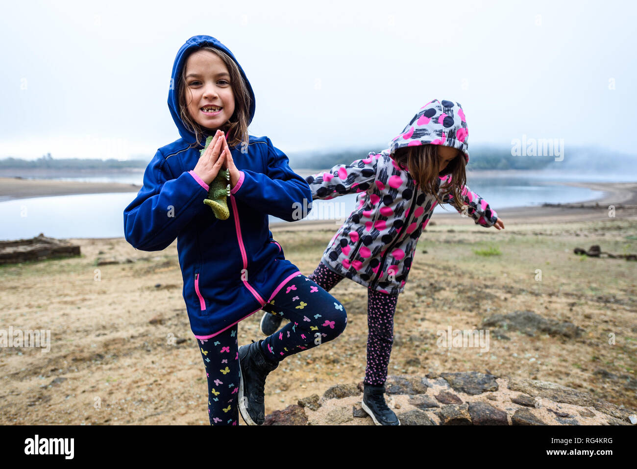 Twin girls standing on remains of ancient roman water well. Children ...