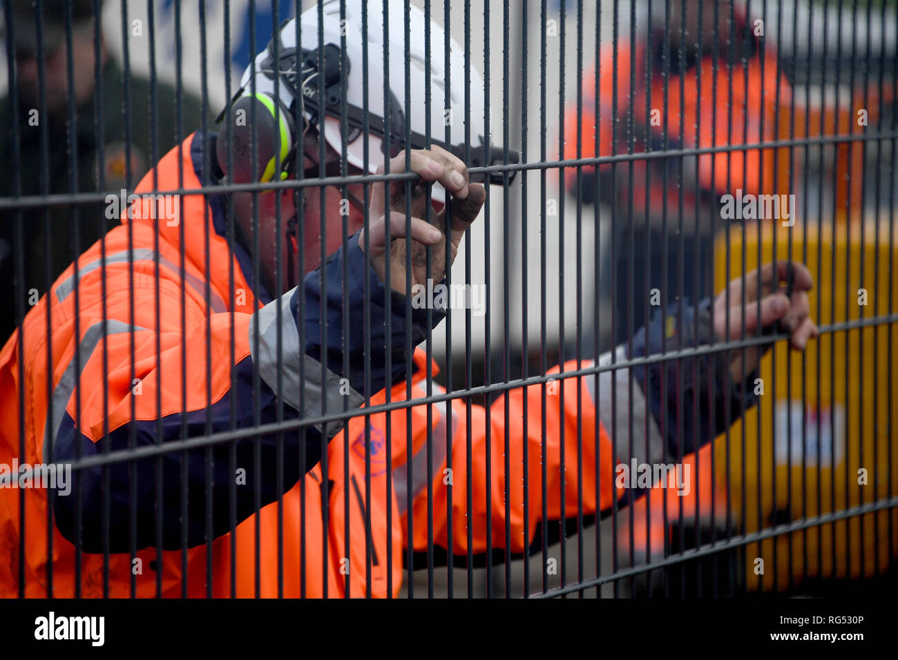 28 January 2019, Denmark, Padborg: A worker holds a fence element on ...