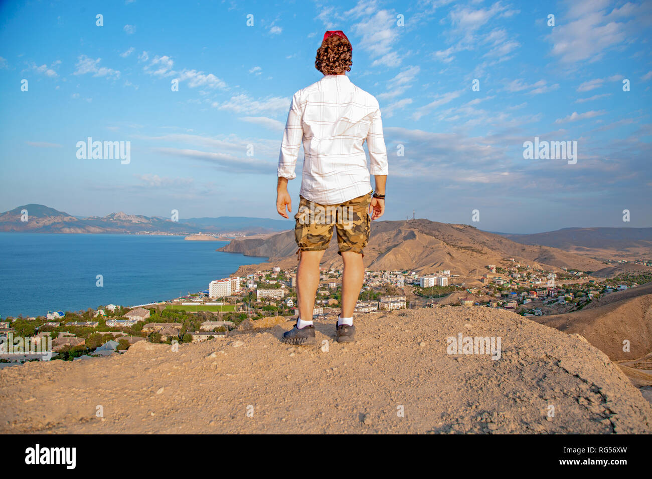 A man overlooking a panoramic view of a beautiful coastline from the ...