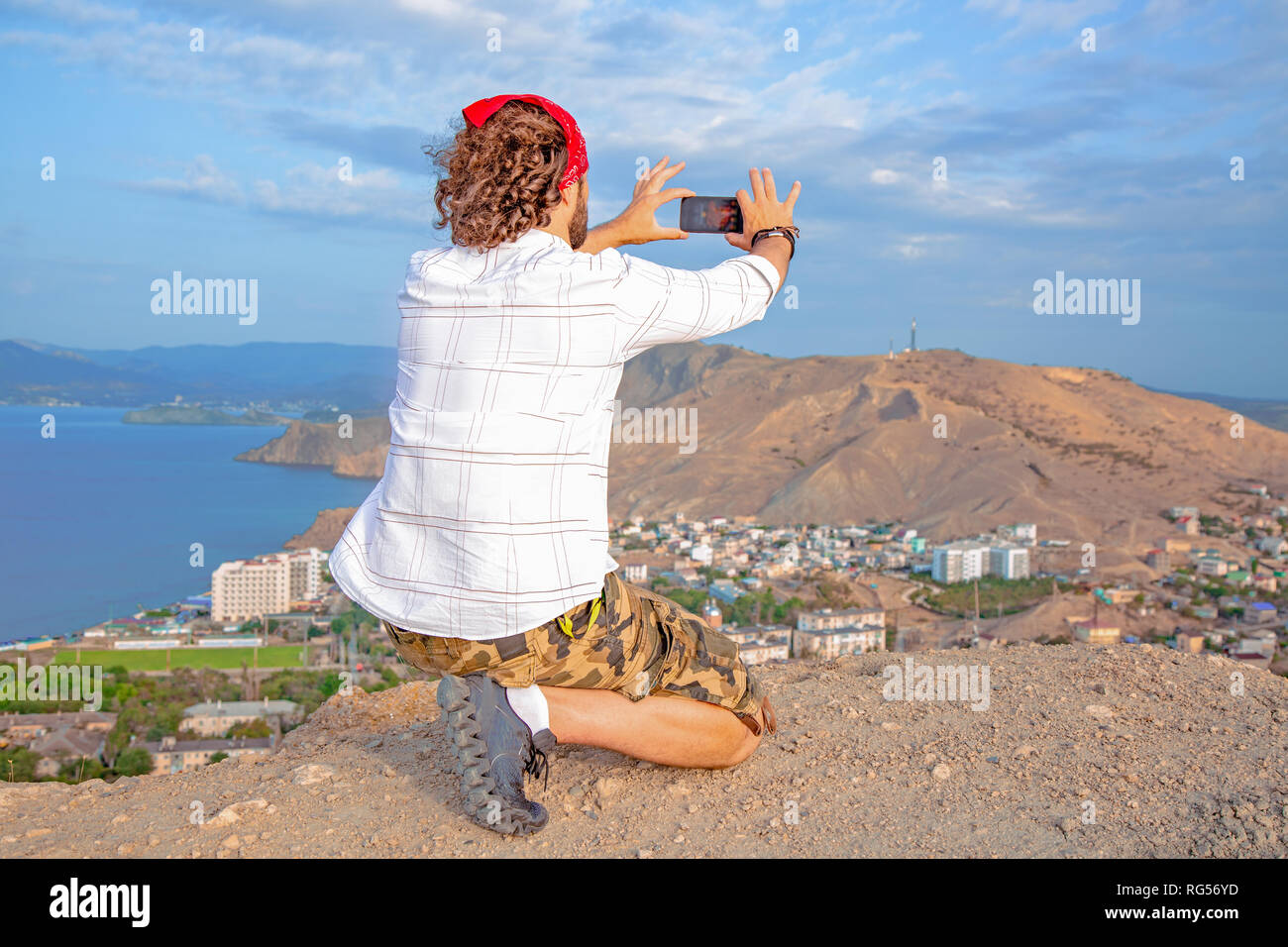 A man overlooking a panoramic view of a beautiful coastline from the ...