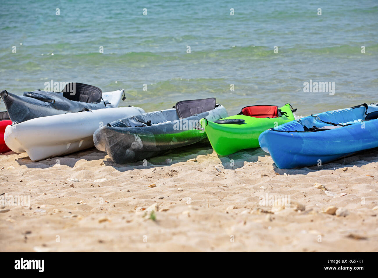 Colourful kayaks on sandy beach. The concept of active rest Stock Photo ...