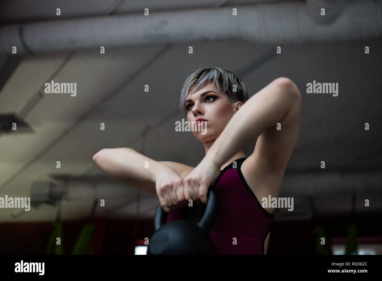 Woman doing kettle bell exercise in a gym Stock Photo - Alamy