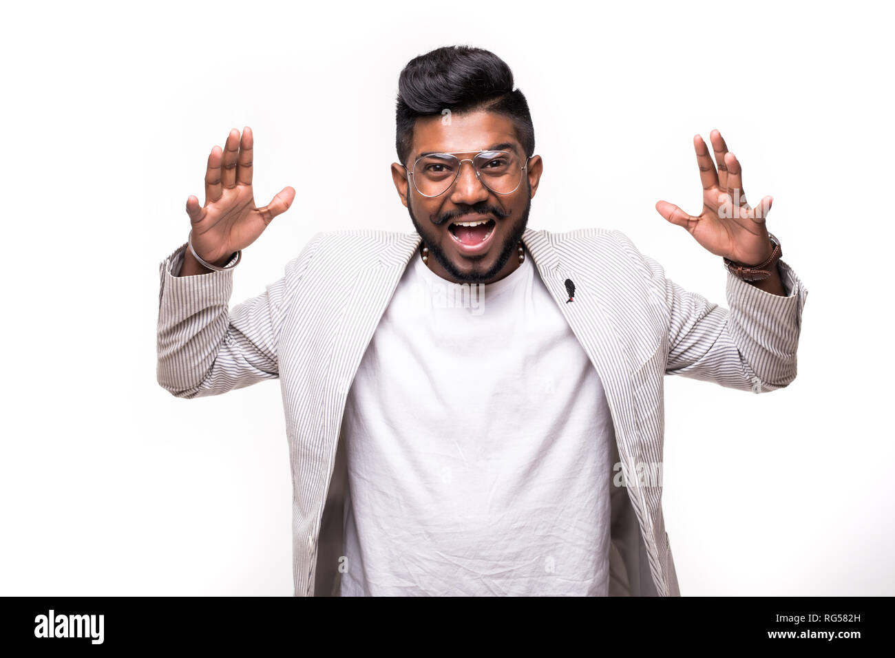 Portrait of a crazy indian hipster man shouting on a white background ...