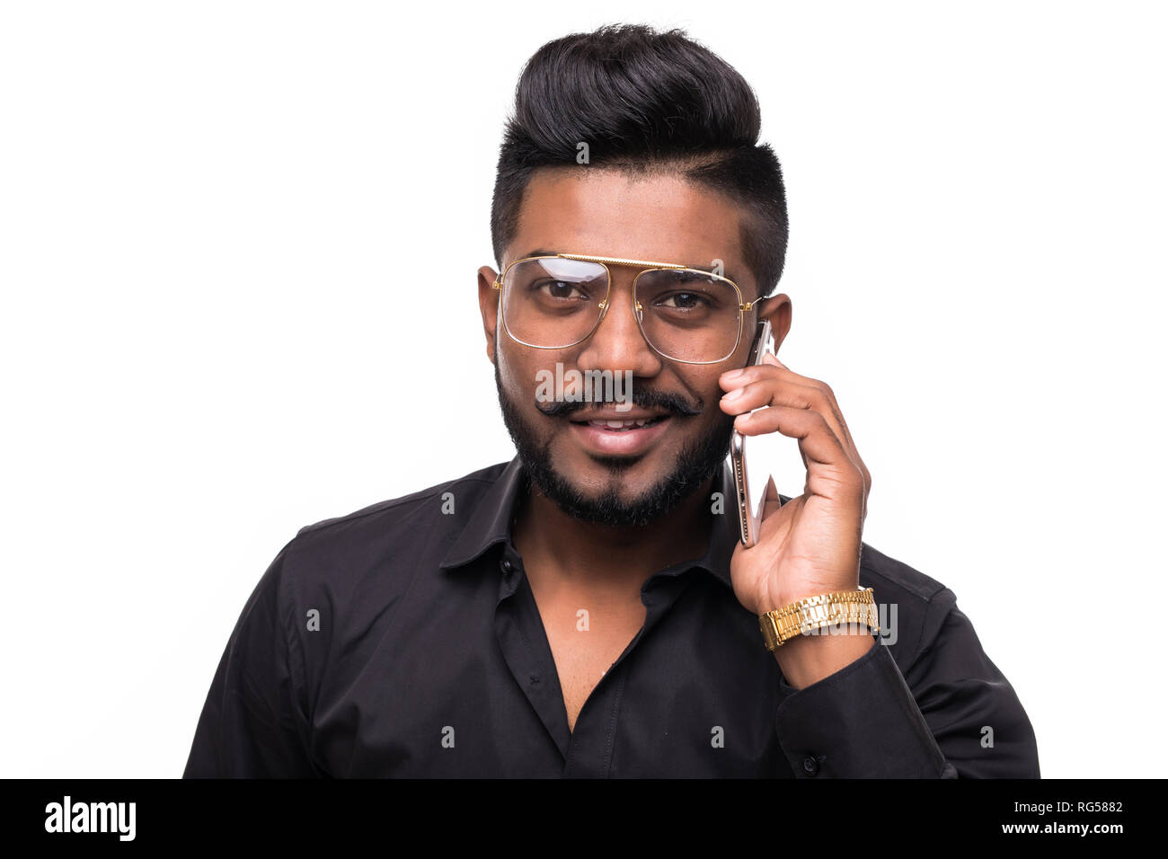 Young Indian man talking on mobile phone isolated against white ...