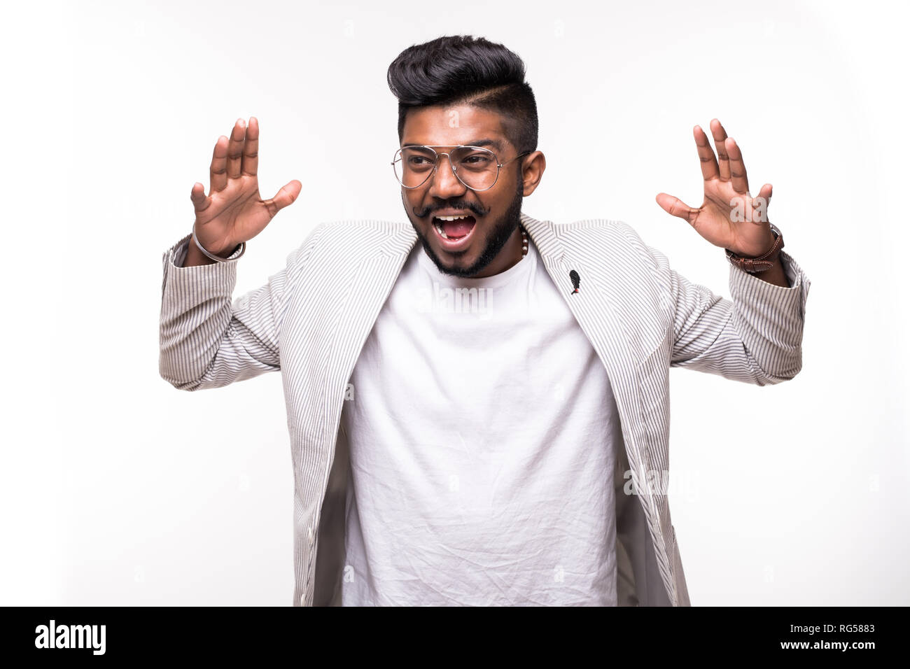Portrait of a crazy indian hipster man shouting on a white background ...