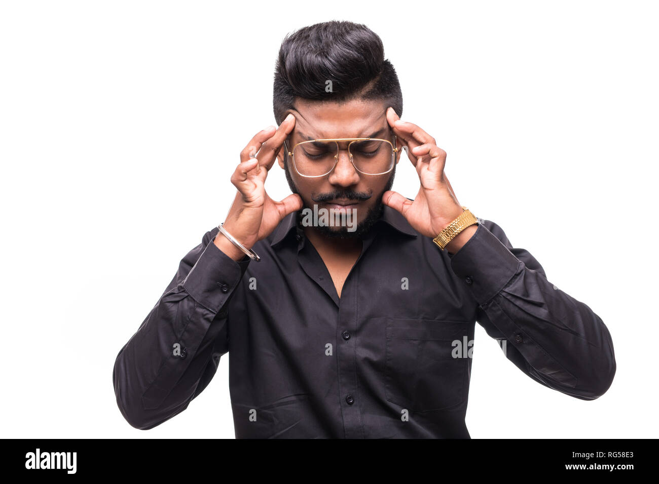 Young stressed Indian man having headache isolated on white background ...