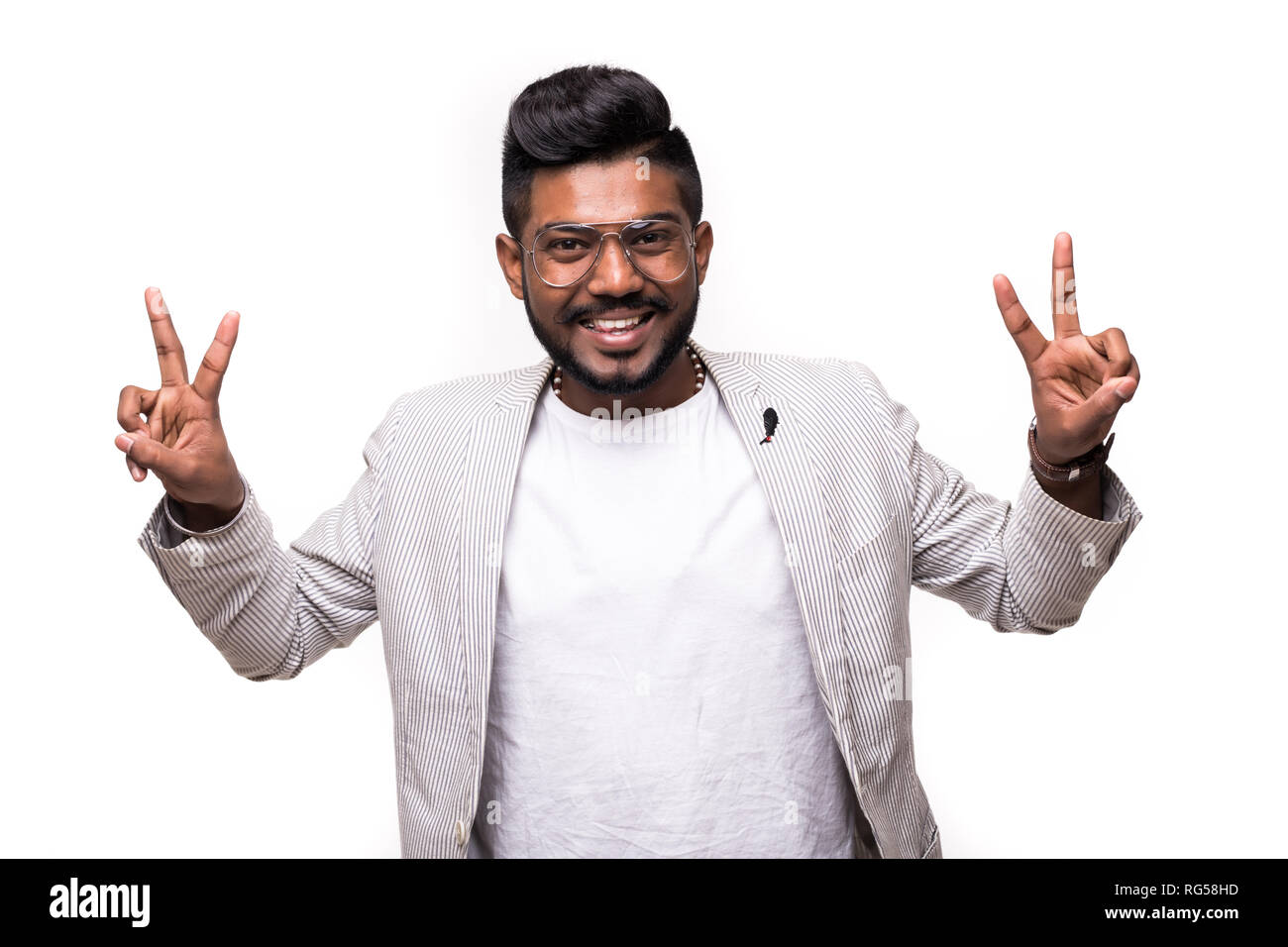 Handsome indian hipster man showing v-sign on white background Stock ...