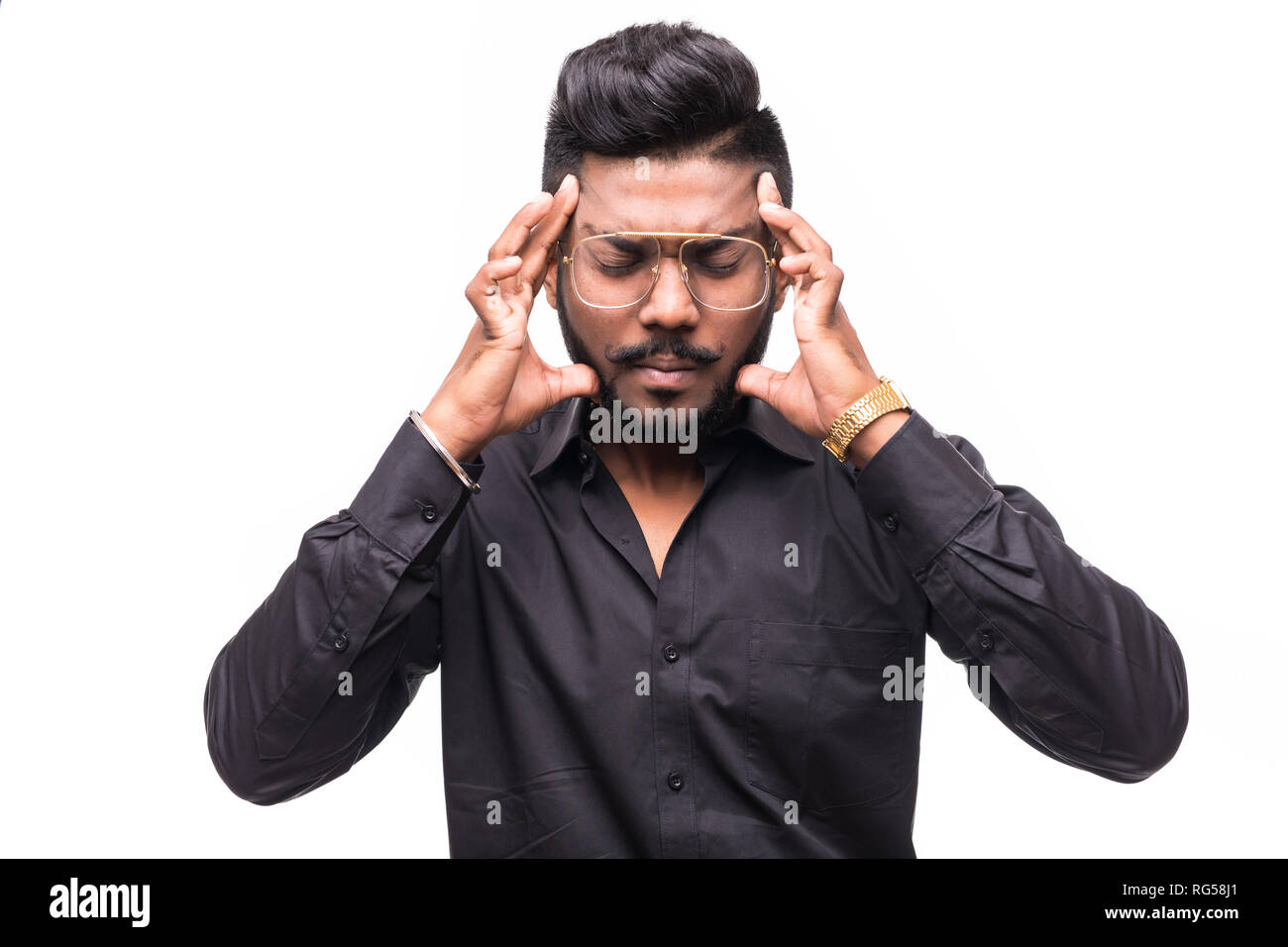 Young stressed Indian man having headache isolated on white background ...