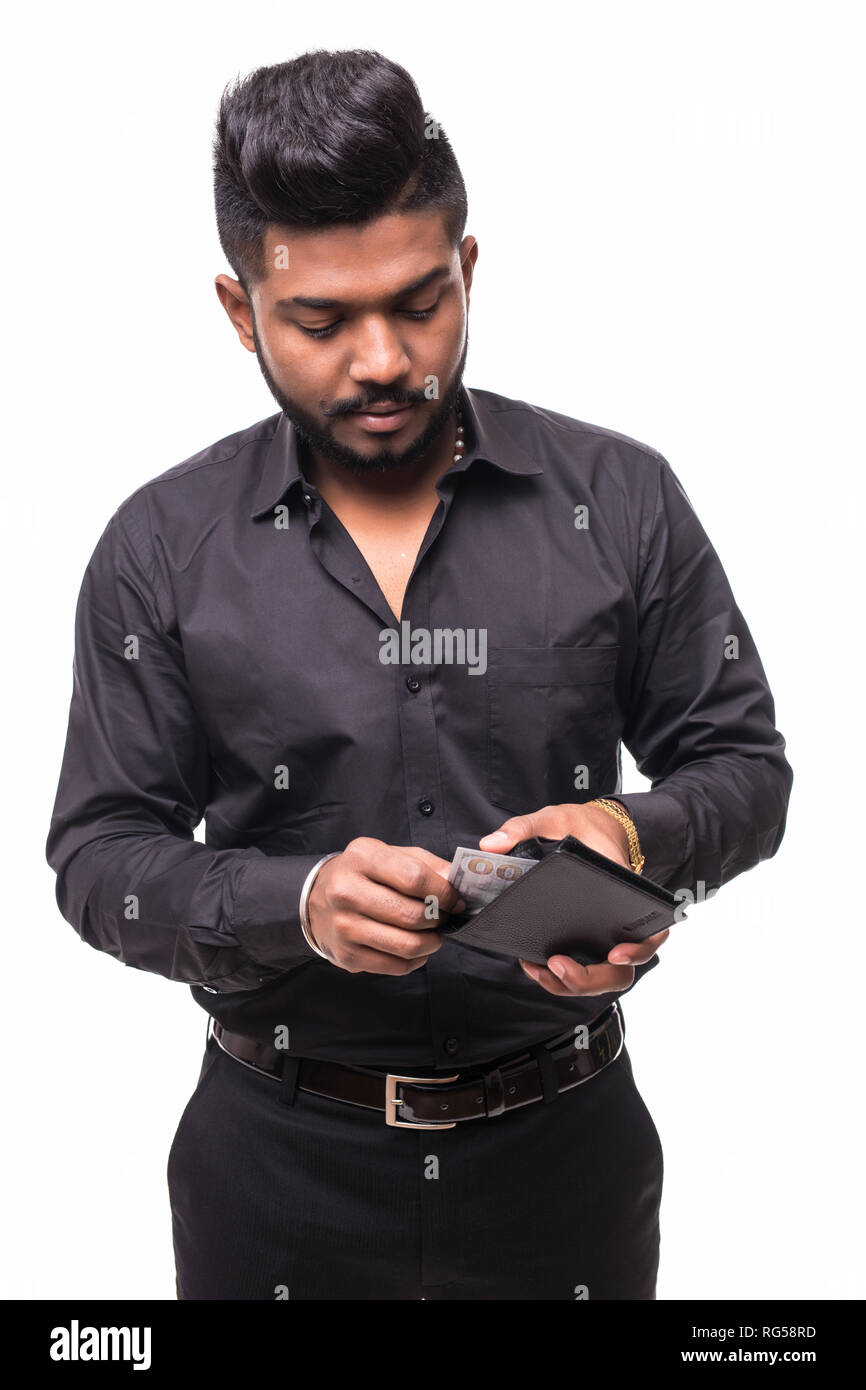 Portrait of a confident man holding wallet full of money and looking at ...