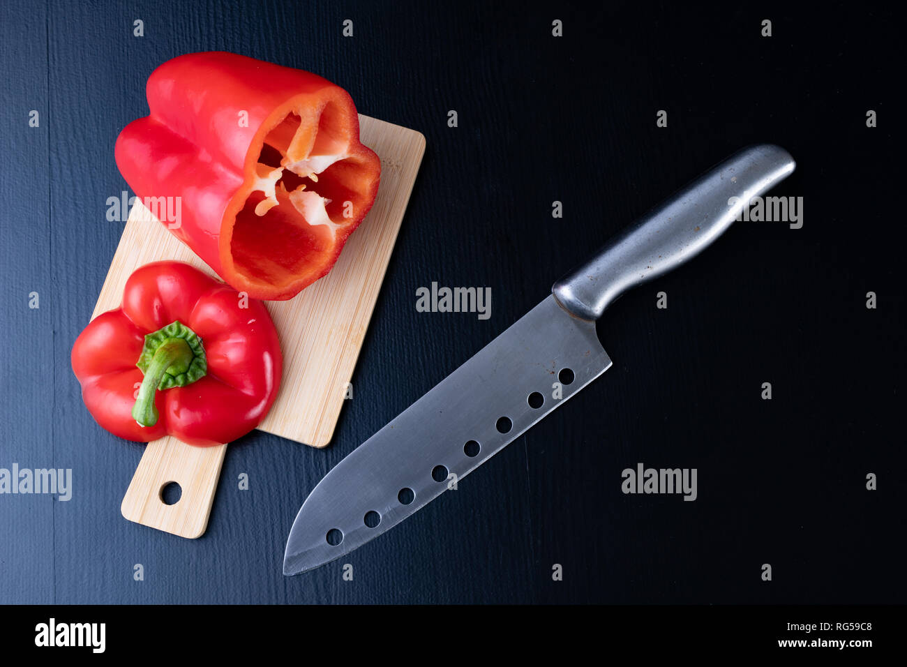Big sweet red paprika on a kitchen board. Vegetables on the kitchen ...