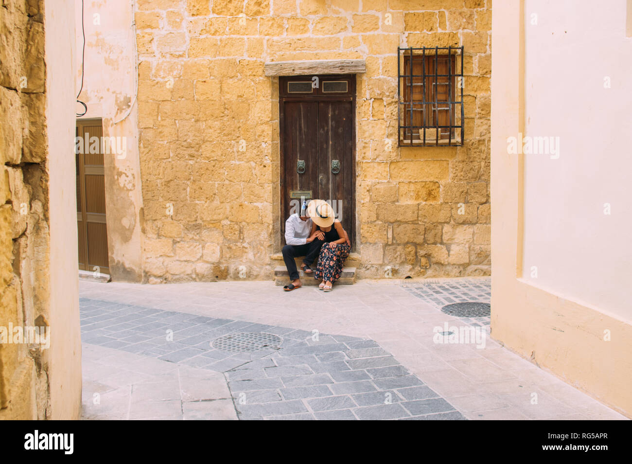 Man kissing woman in old city, Gozo, Malta Stock Photo - Alamy