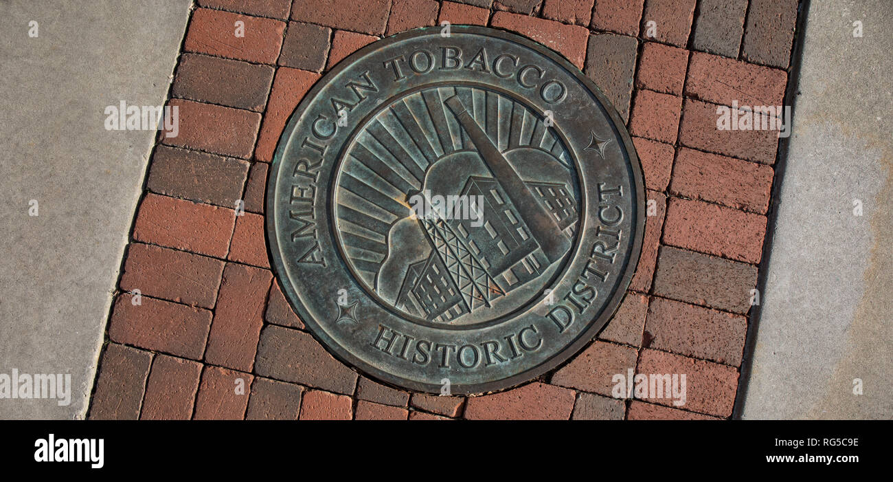 A manhole cover with concrete and brick sidewalk Stock Photo - Alamy