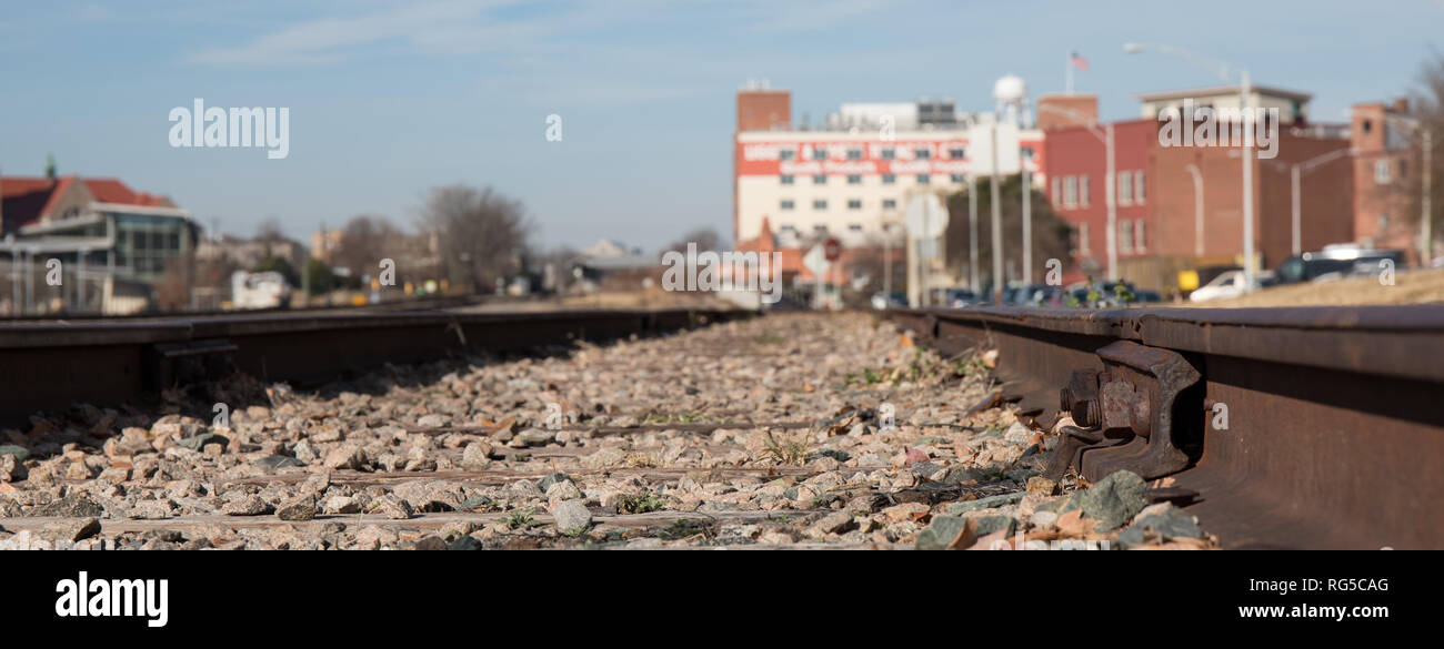 Railroad tracks from the ground level in an urban setting Stock Photo ...