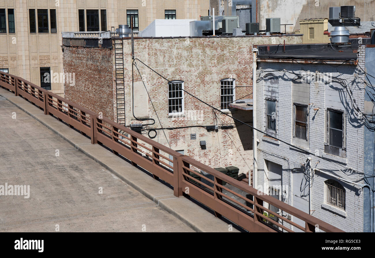 View of the back of buildings on an alleyway from an elevated parking ...
