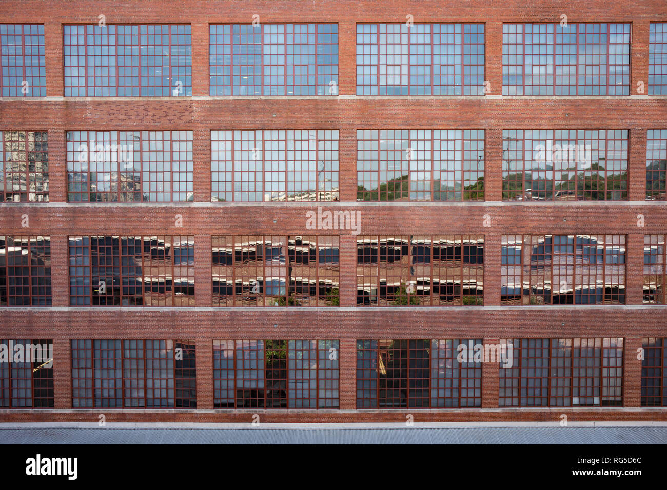 Exterior photo of large warehouse windows Stock Photo - Alamy