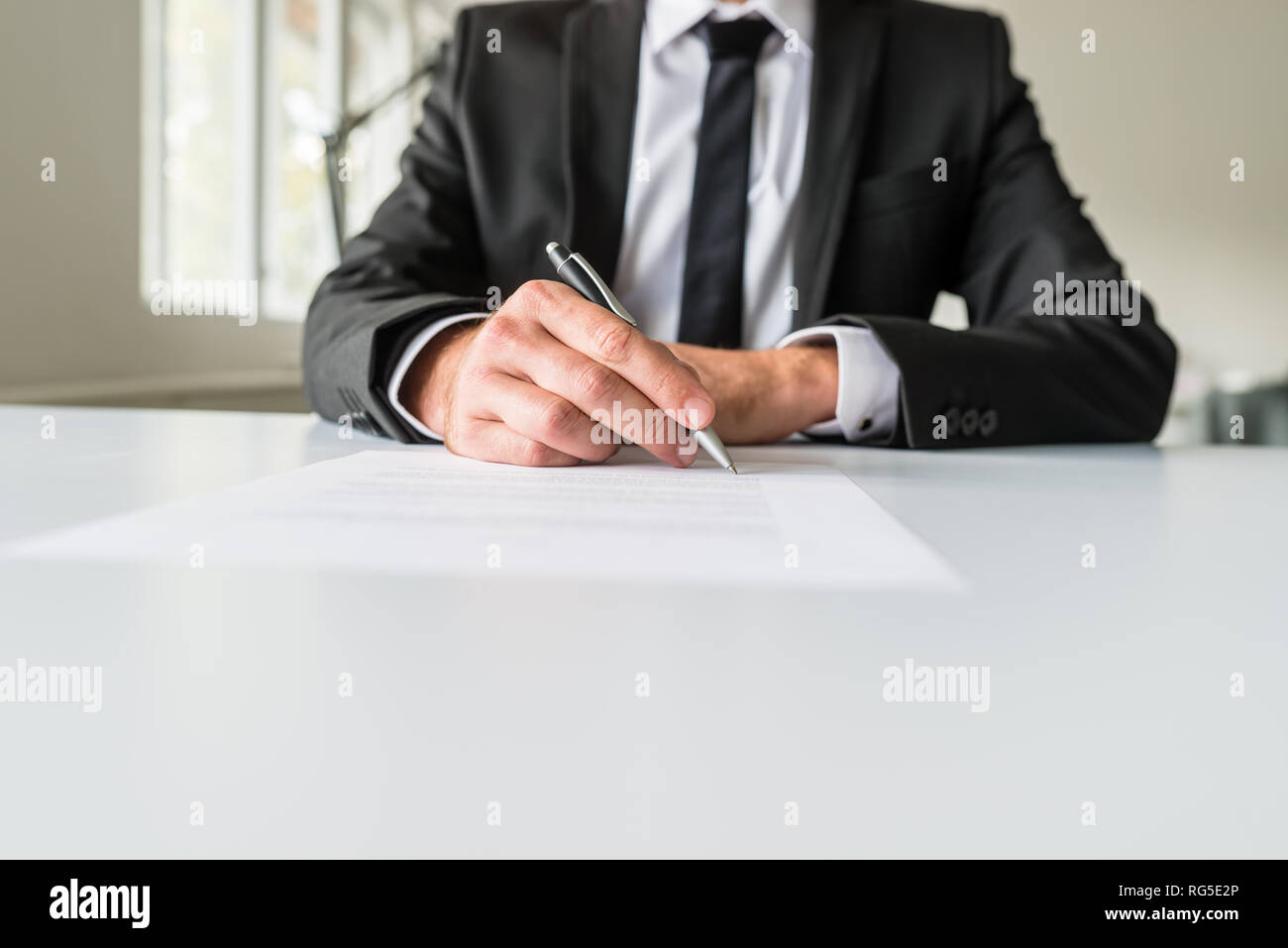 Front view of businessman or employer sitting at his office desk ...