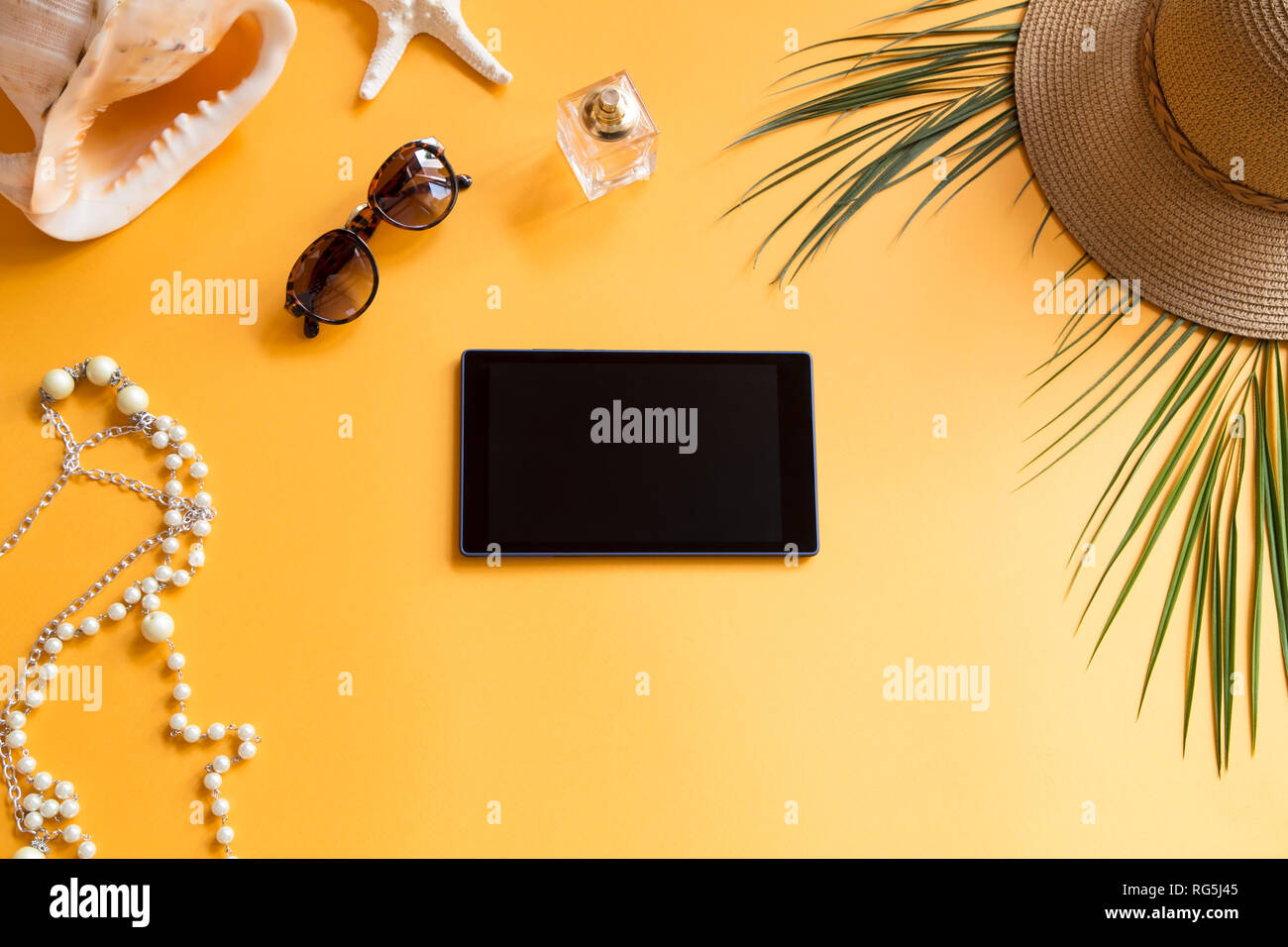 Summer background with a black tablet Stock Photo - Alamy