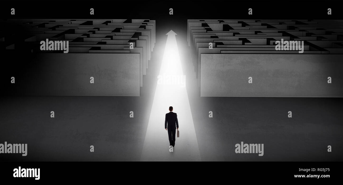 Businessman going straight ahead on a lighted carpet arrow between two ...