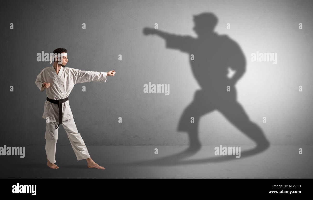 Young karate man confronting with his own shadow Stock Photo - Alamy