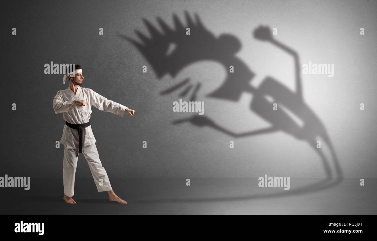 Young karate man fighting with a big black scary shadow Stock Photo - Alamy