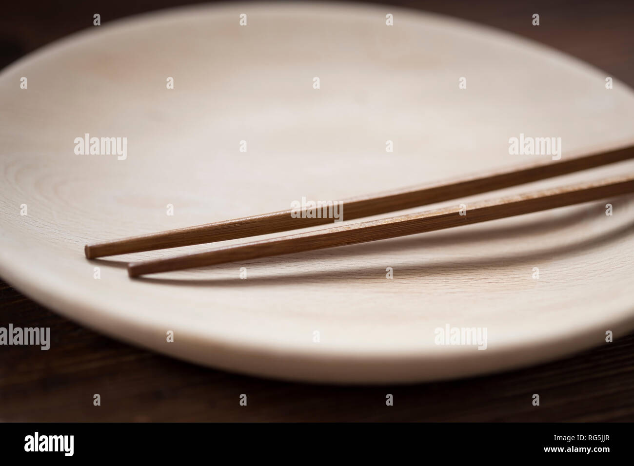 Wooden plate and the chopsticks Stock Photo - Alamy