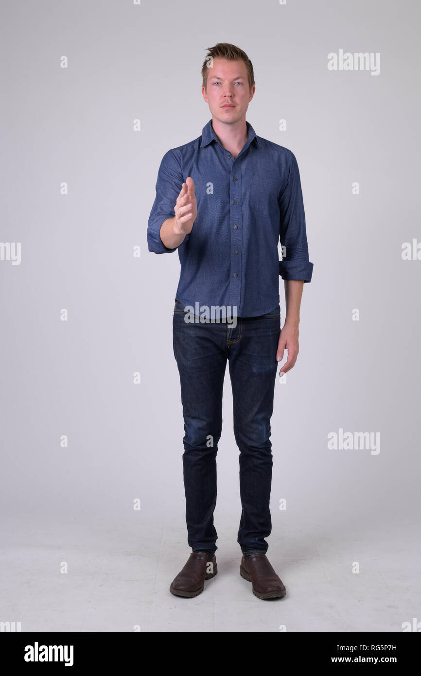 Full body shot of young handsome businessman giving handshake Stock ...