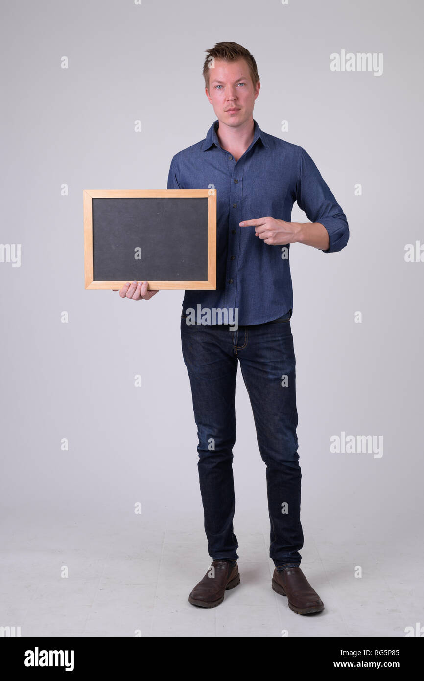 Young businessman holding blackboard and pointing finger Stock Photo ...
