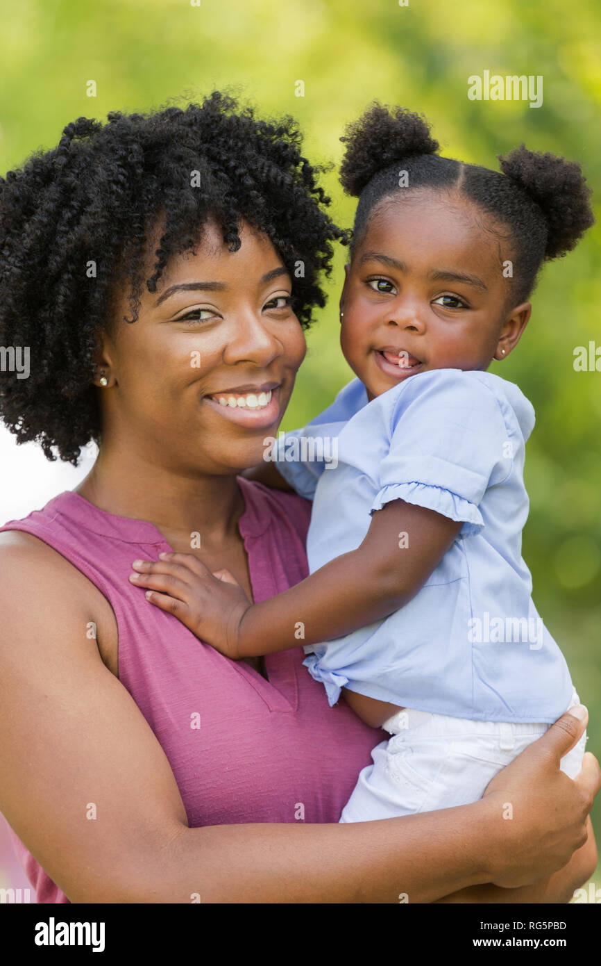African American mother laughing and hugging her daughter Stock Photo - Alamy