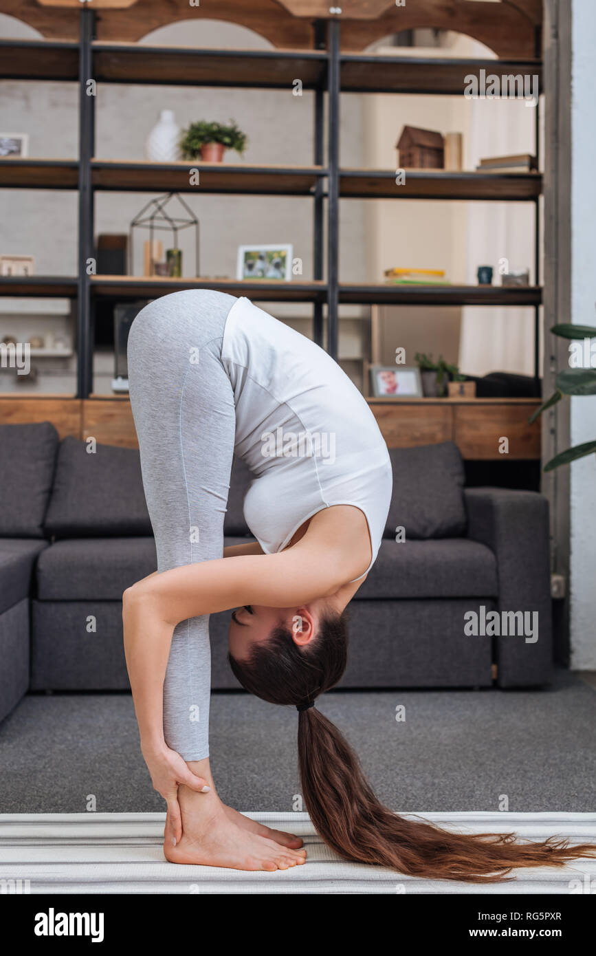 Standing forward bend pose hi-res stock photography and images - Alamy