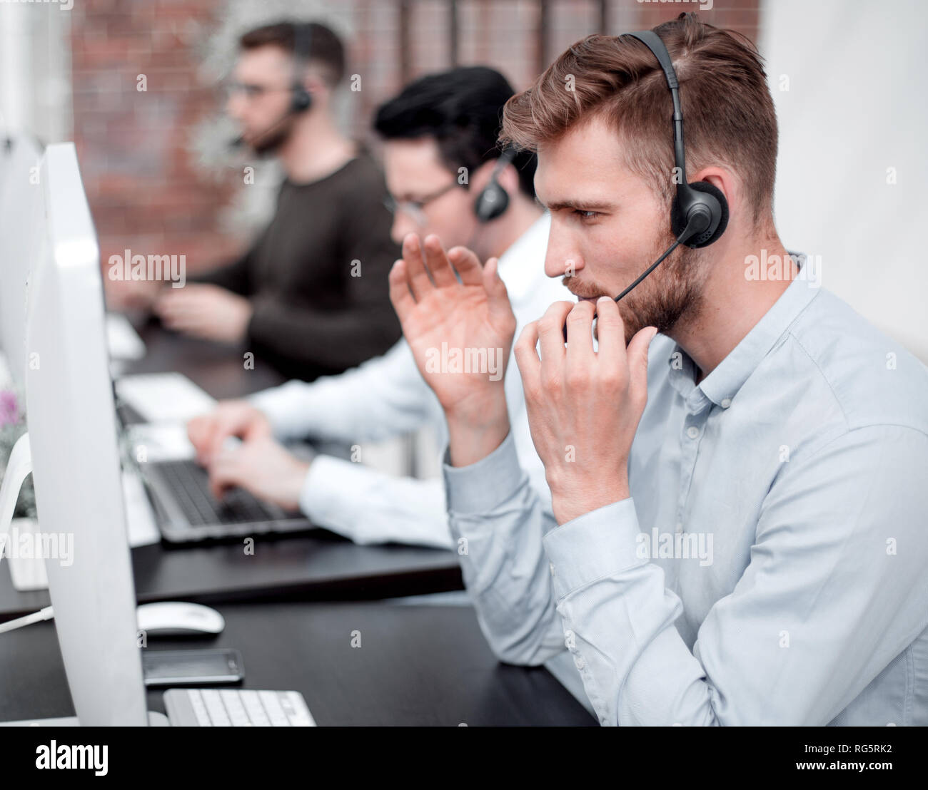 employees with a headset in the workplace in the business center Stock ...