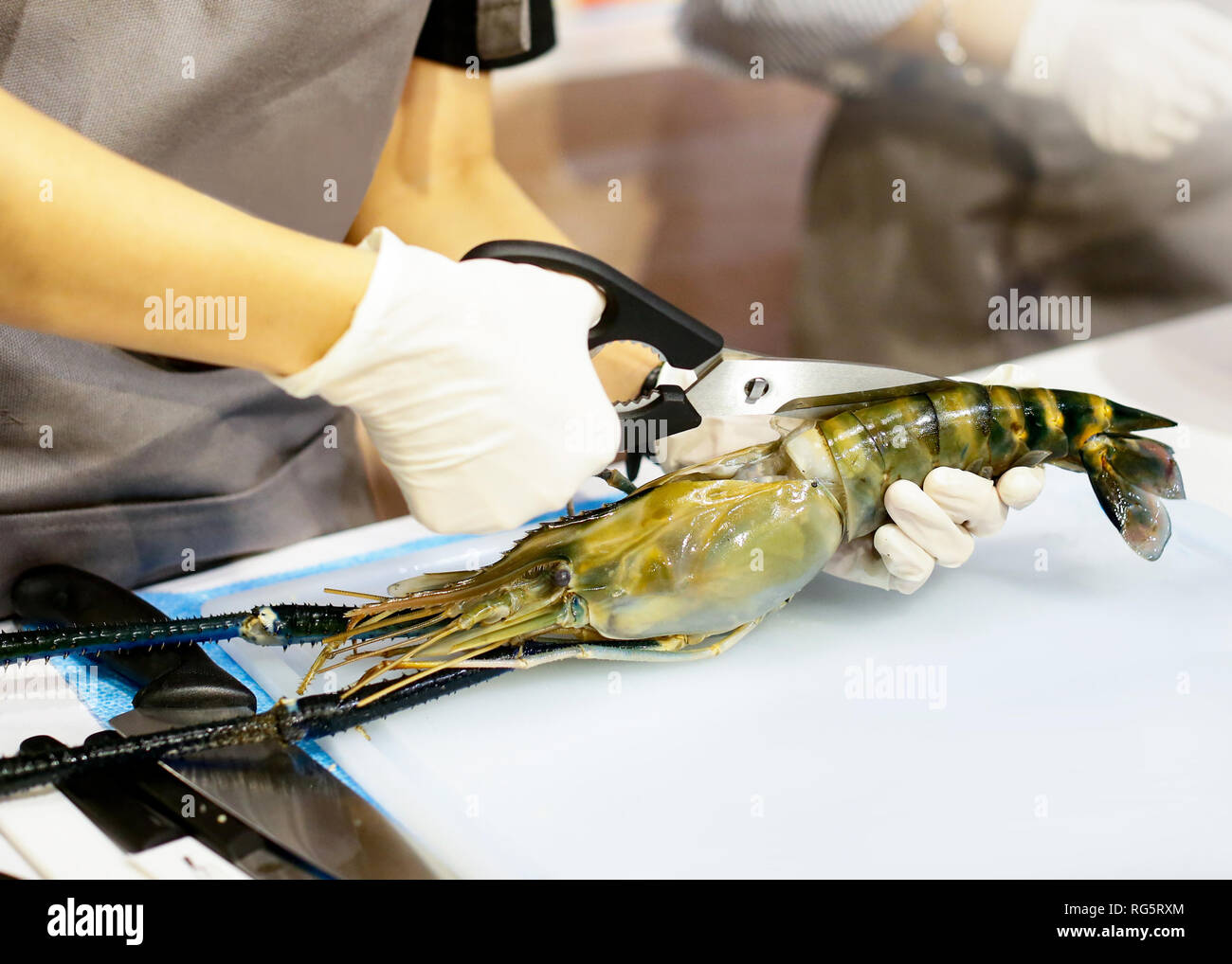 chef cooking seafood, Hand cutting raw black tiger prawn Stock Photo ...