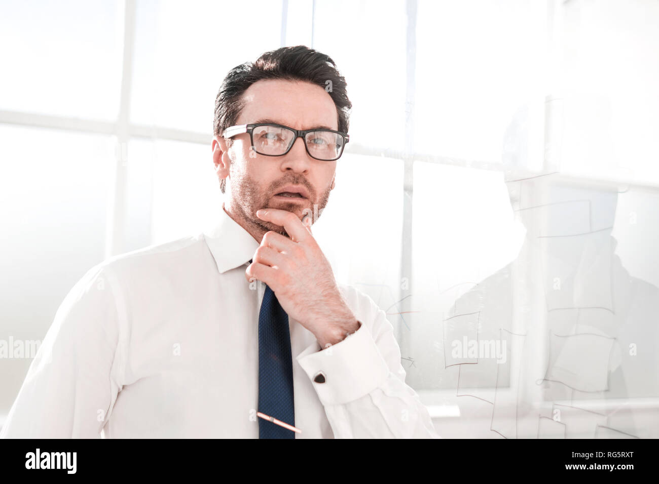 serious brooding businessman standing in the office Stock Photo - Alamy