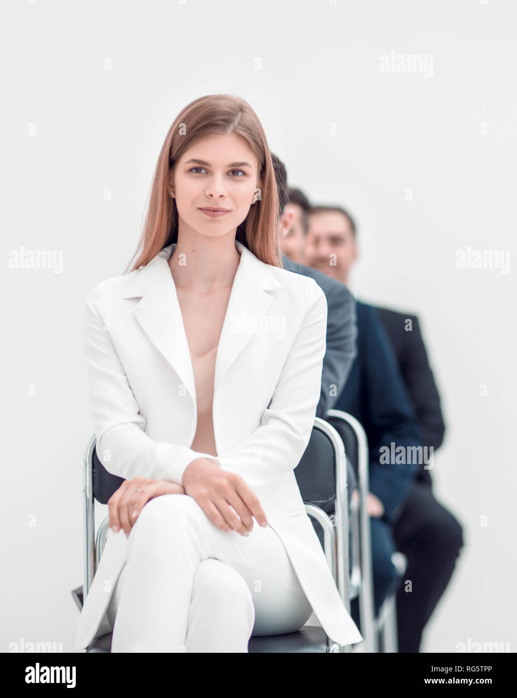 young professionals sitting in line Stock Photo - Alamy