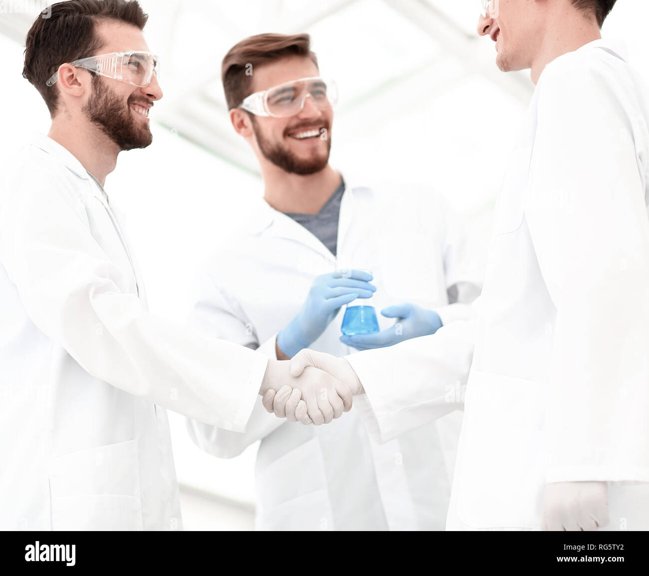 blurred image of a handshake between scientists Stock Photo - Alamy