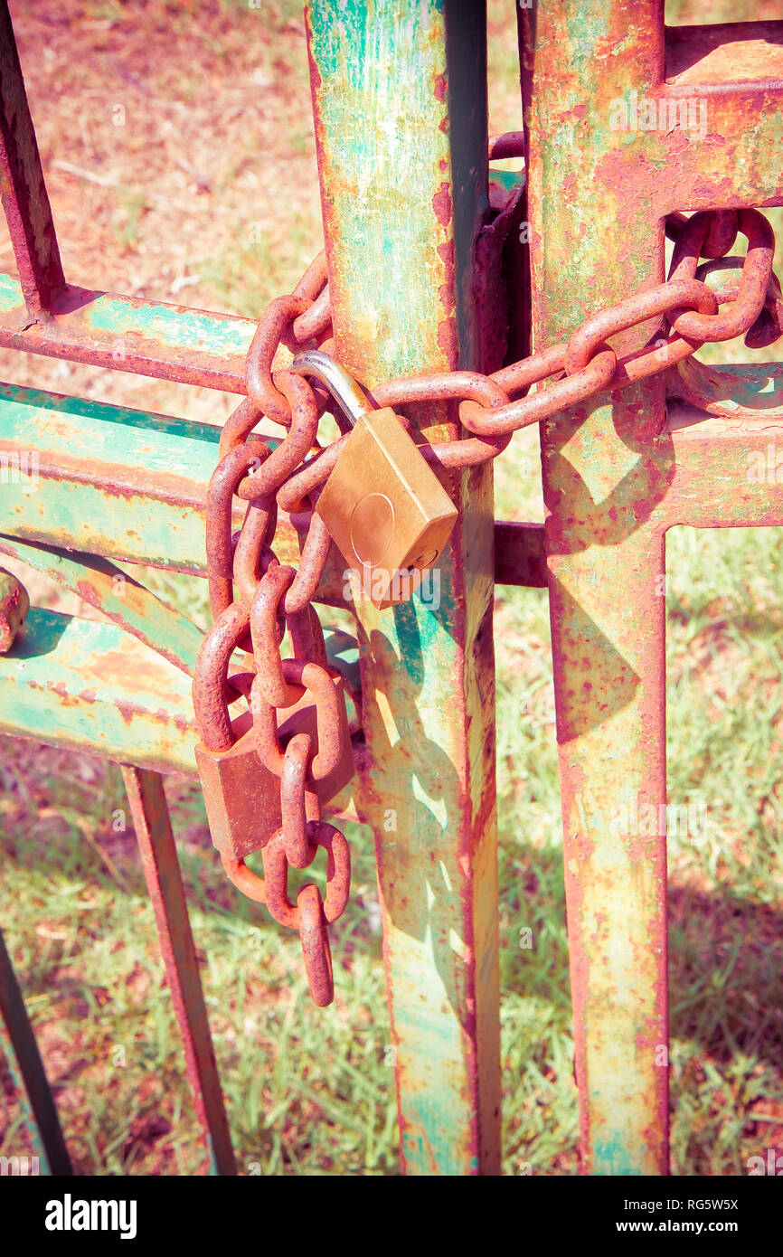Rusty metal gate closed with padlock - concept image Stock Photo - Alamy
