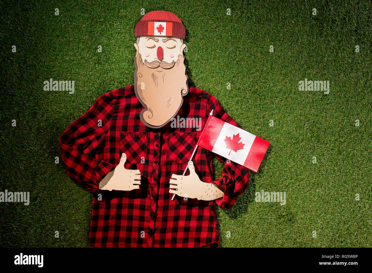 cardboard man in plaid shirt holding canadian flag and showing thumbs ...