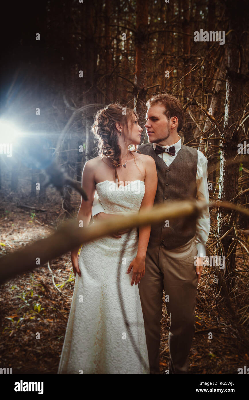 bride and groom in the forest of firs Stock Photo - Alamy