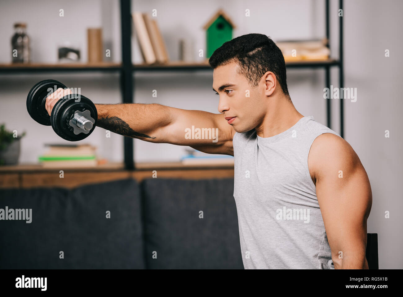 strong mixed race sportsman workout with heavy dumbbell Stock Photo - Alamy