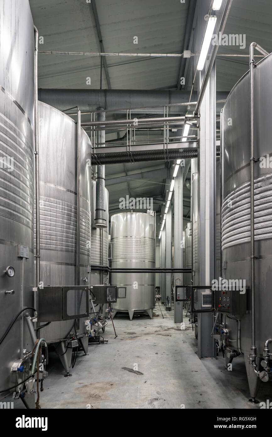 Inside of a modern winery with controlled temperature wine barrels ...