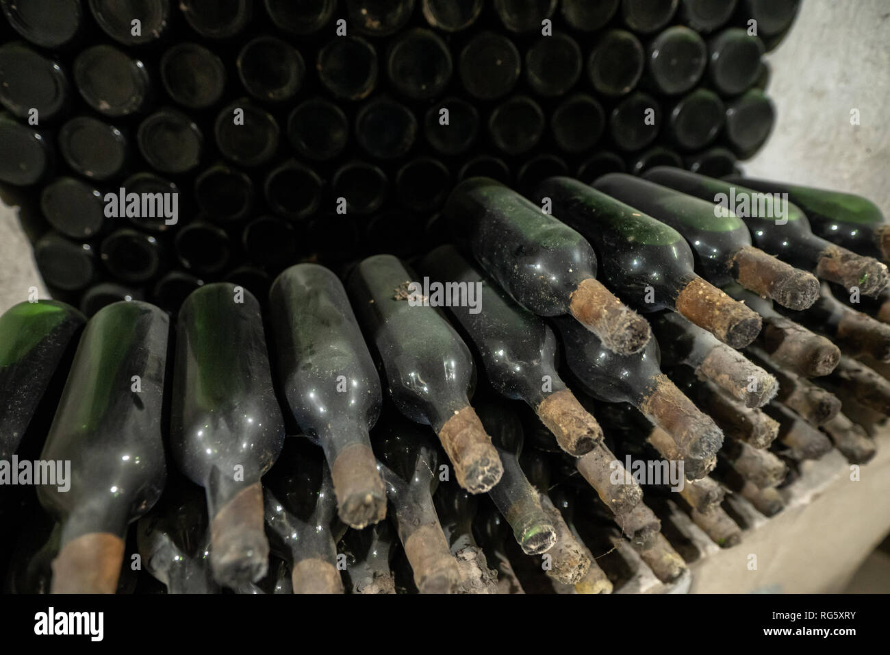 Dusty old wine bottles in an underground wine cellar Stock Photo - Alamy