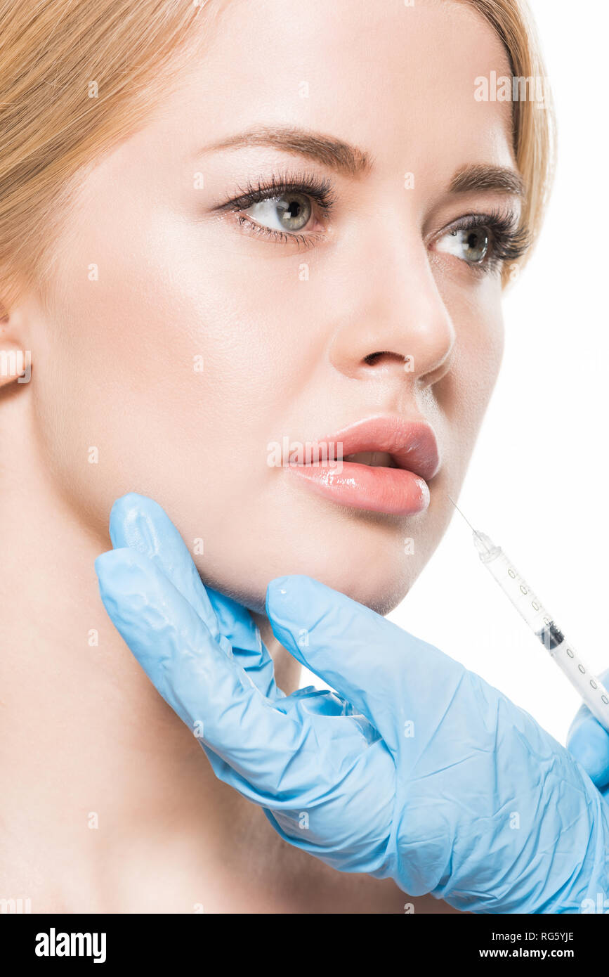 beautiful young woman receiving beauty injection in lips isolated on ...