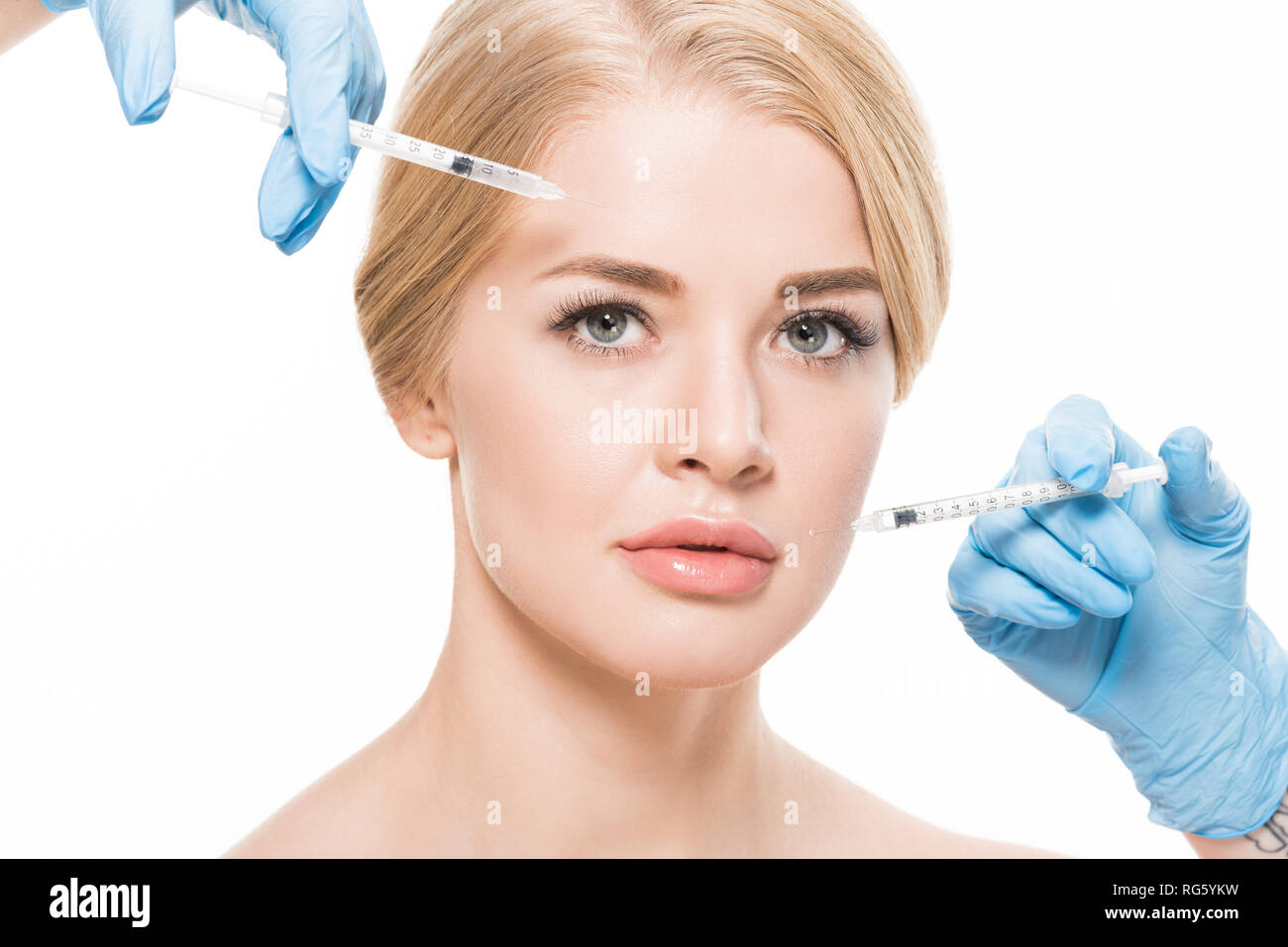 cropped shot of young woman receiving beauty injections in face ...