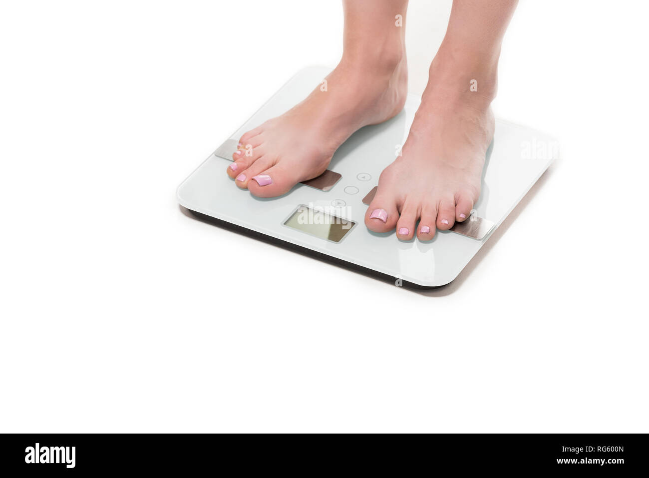 cropped shot of female feet standing on scales isolated on white Stock ...