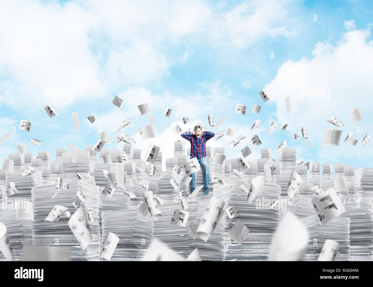 Attractive man sitting on pile of paper documents Stock Photo - Alamy
