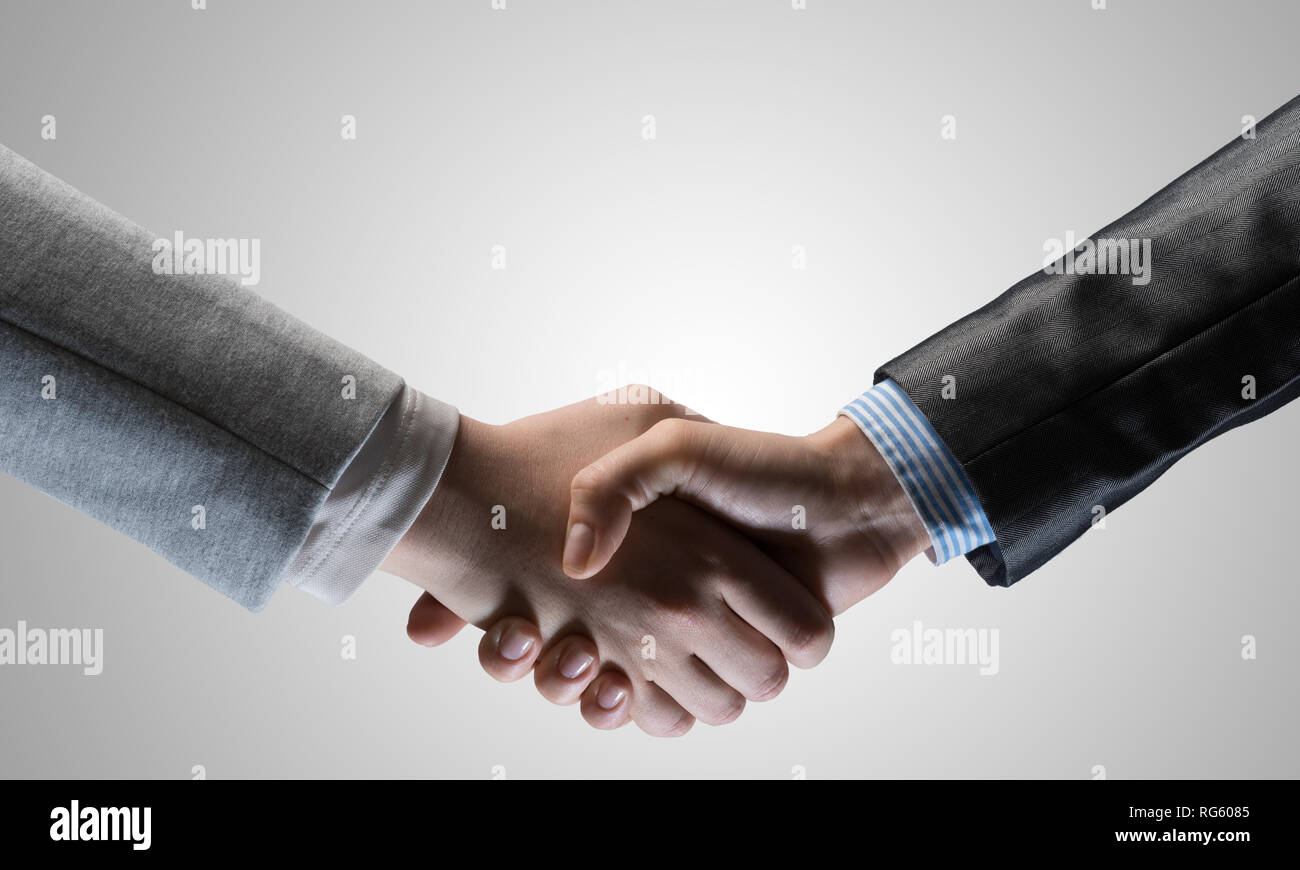 Business handshake as idea for unity and cooperation or greeting. Mixed ...
