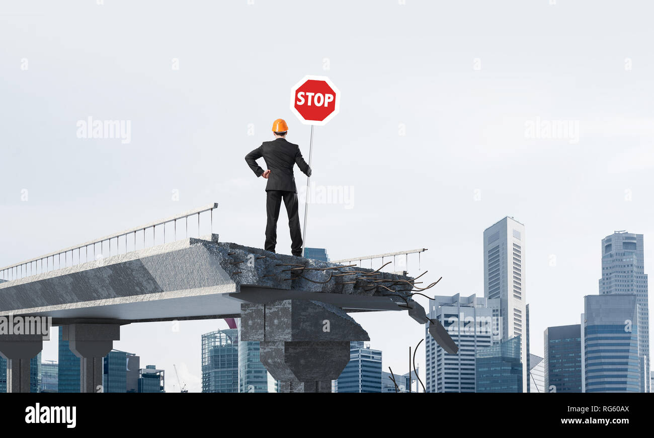Confident engineer holding street safety sign Stock Photo - Alamy
