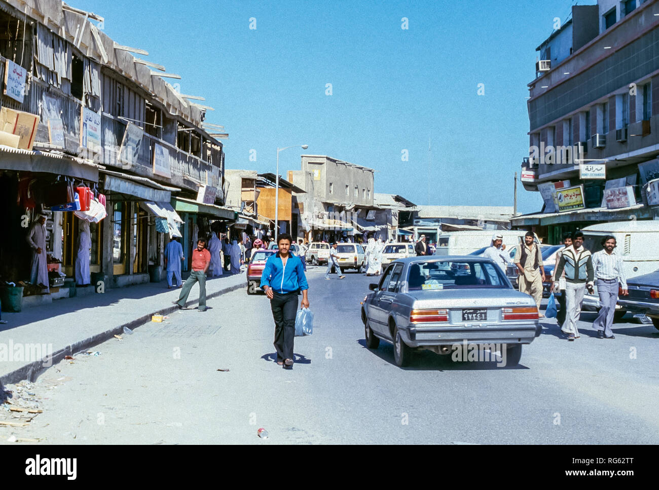 Qatar. Men of various ethnic groups out shopping in Doha souk-market ...