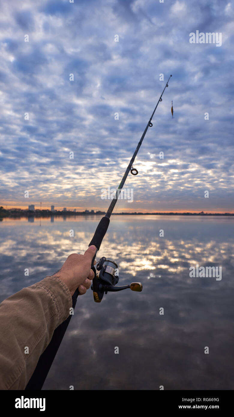 Man holding fishing rod Stock Photo - Alamy